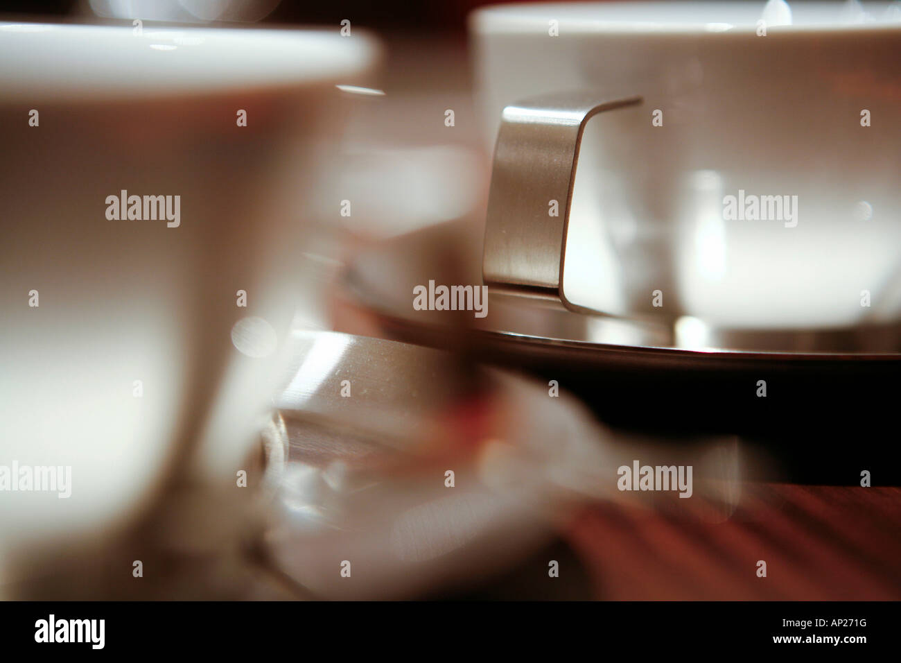 Cups and saucers on a dining table Stock Photo - Alamy