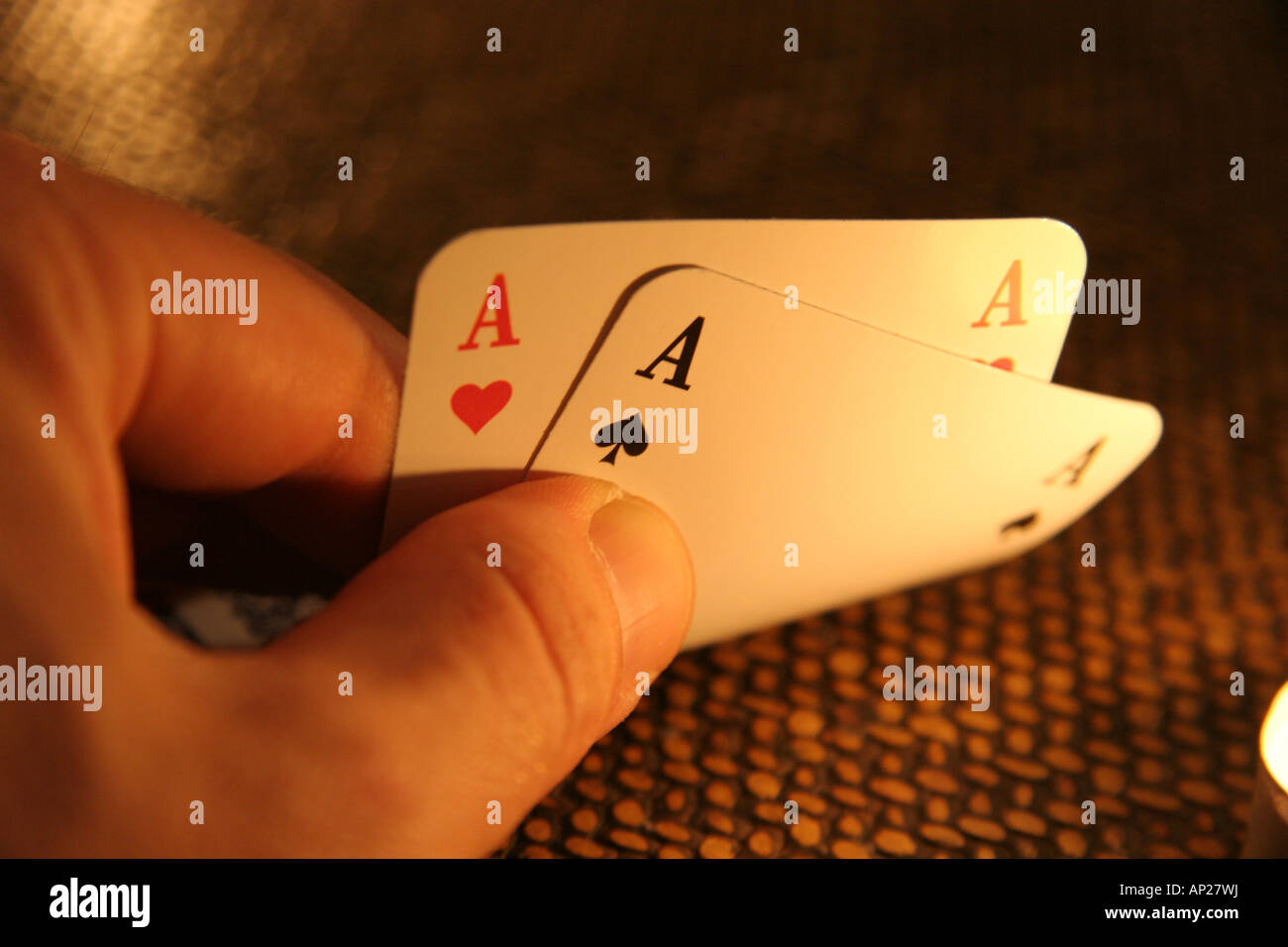 A poker player looking at a pocket of aces Stock Photo - Alamy