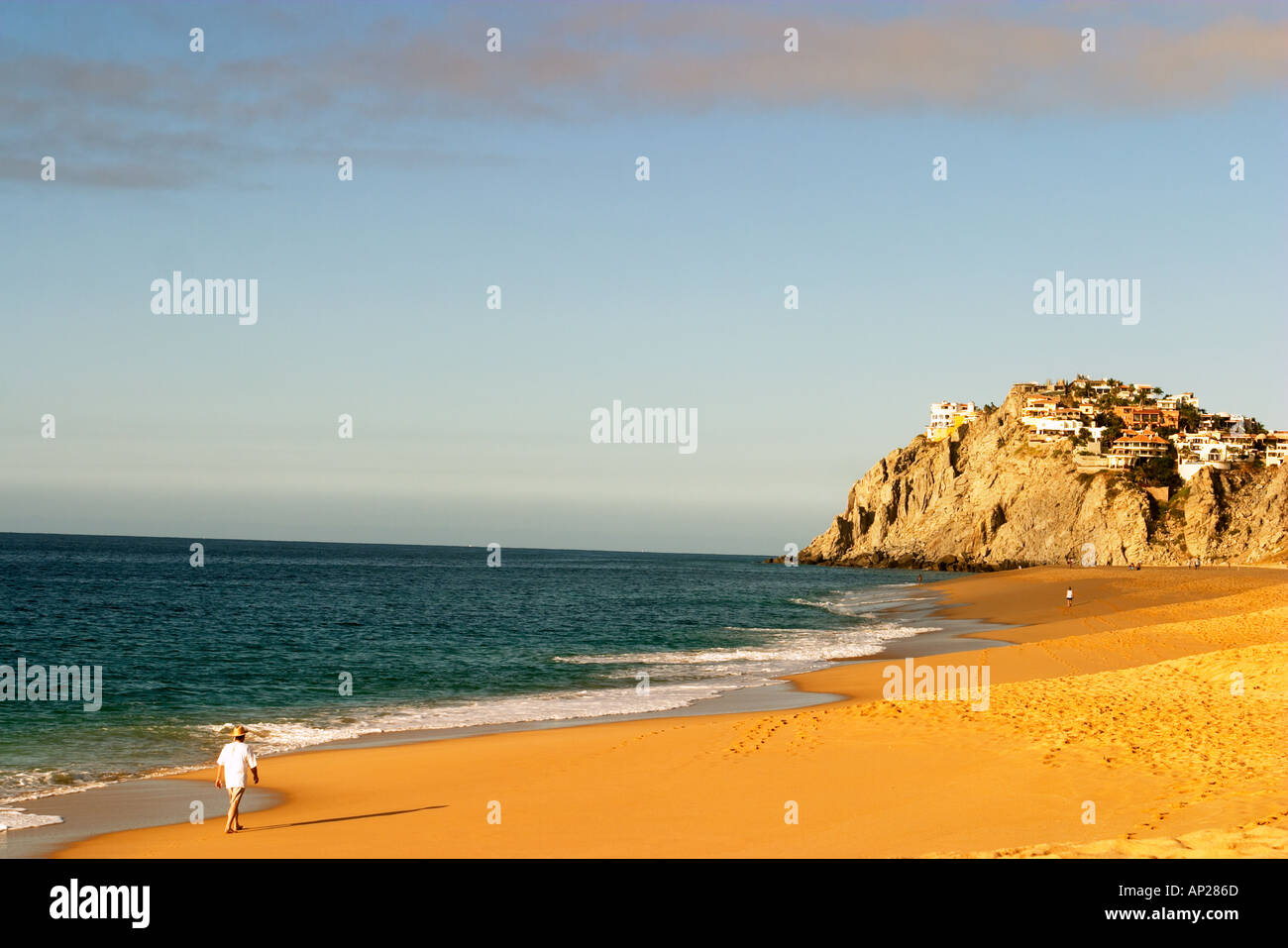 MEXICO Cabo San Lucas People walking along Playa Solmar beach early in ...