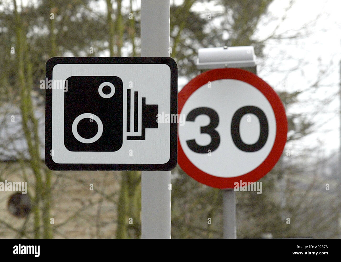 Speed camera warning sign in front of mandatory speed sign Stock Photo ...