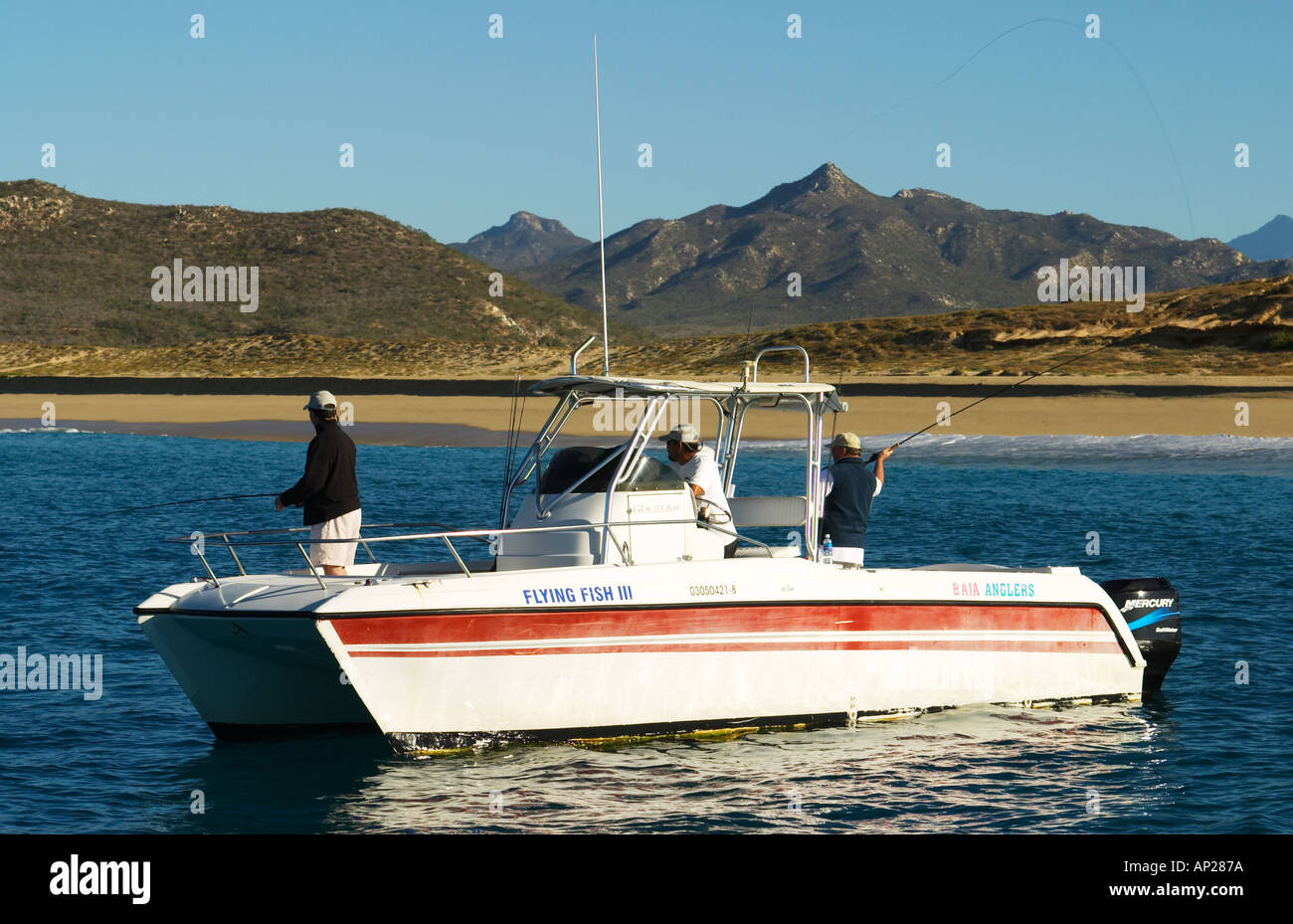 MEXICO Cabo San Lucas Men fly fishing from boat in Pacific Ocean Baja ...