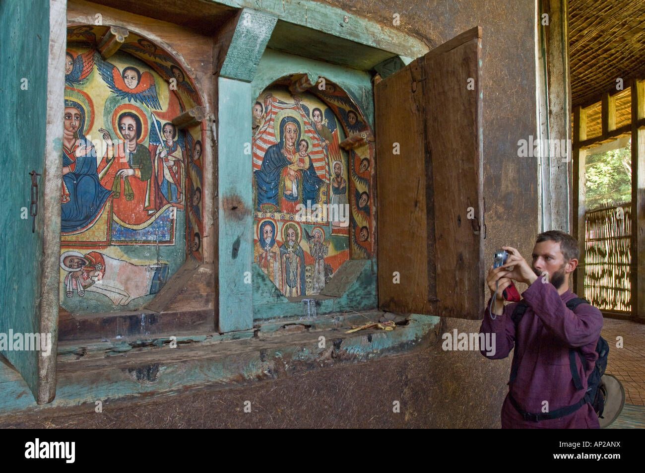 A tourist taking photographs inside the Ura - Kidane Mihret Monastery ...