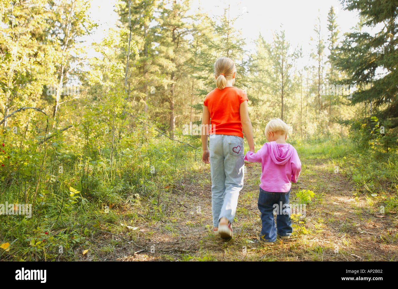 Two children walking down a path Stock Photo - Alamy