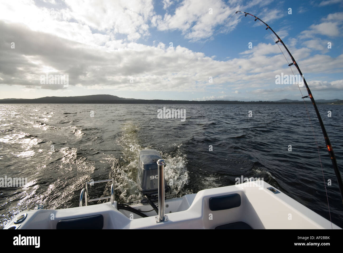 Fishing road trolling from the back of a power boat Stock Photo - Alamy