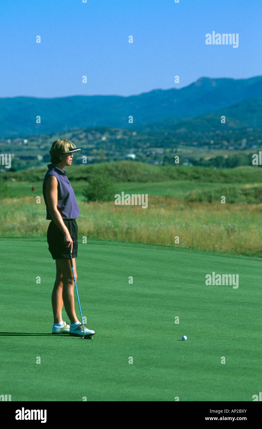 Golfer lining up a putt Haymaker golf course Steamboat Springs Colorado ...
