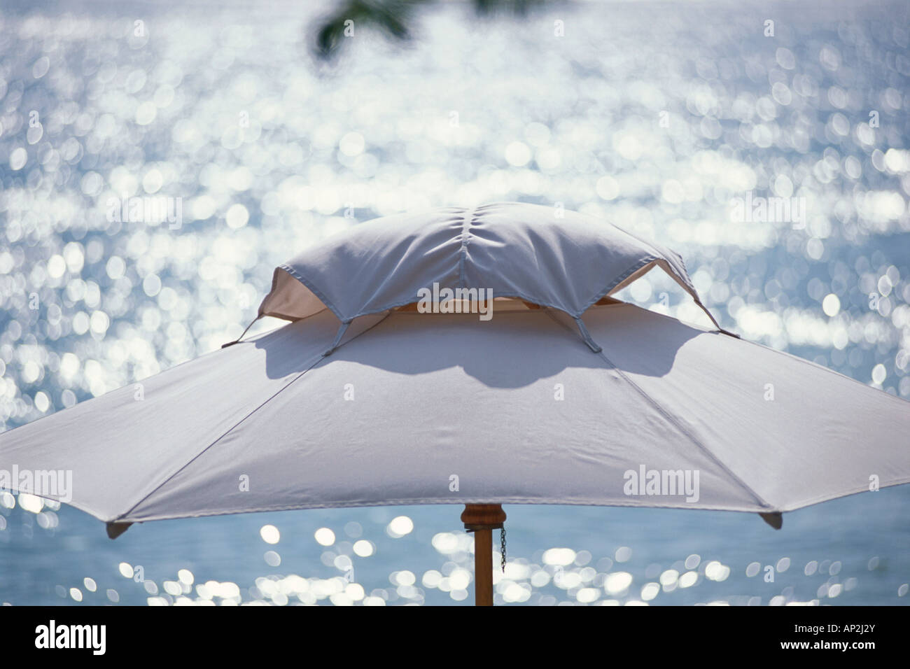 A white sunshade, parasol in front of the sea, Hotel Oberoi, Holiday ...