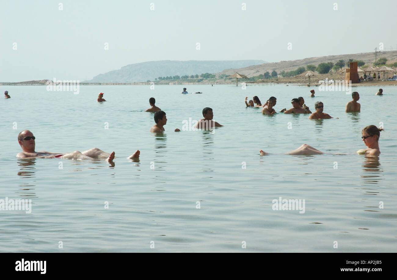A group of tourist relax and float in the Dead Sea Israel enjoying the ...
