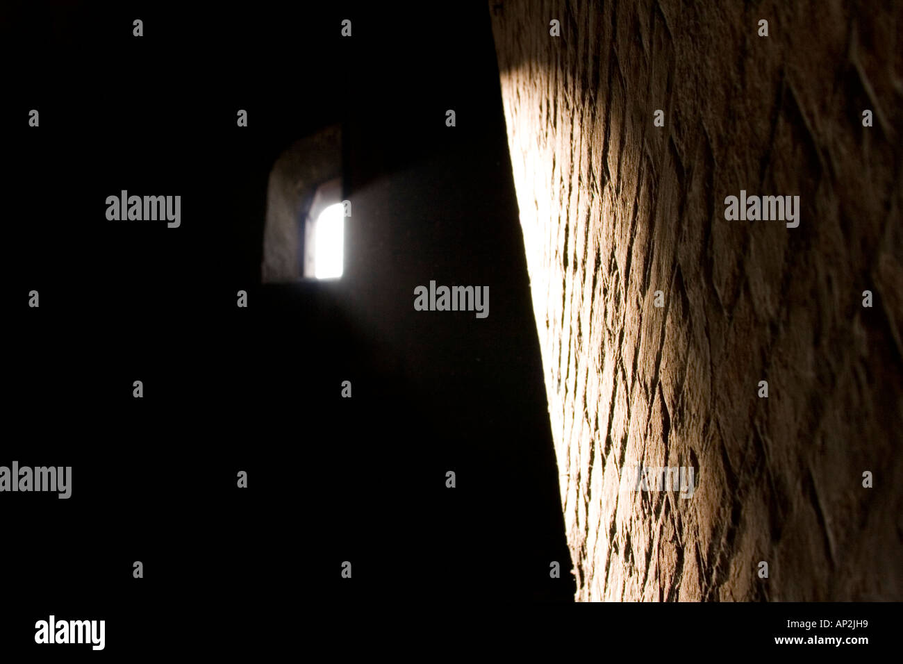Light from an arched window spreads over a brick wall Stock Photo - Alamy