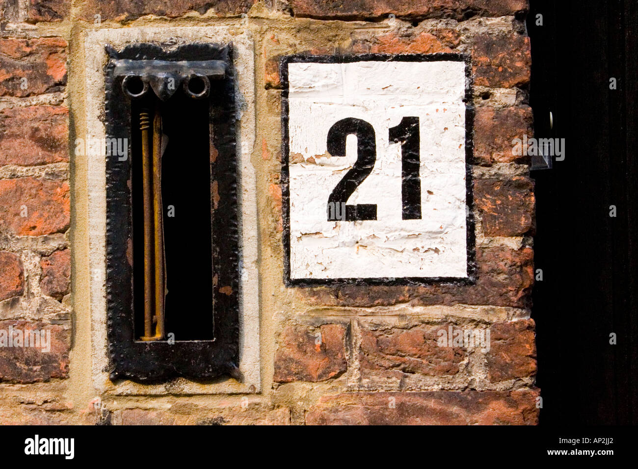 House number sign next to letterbox on a brick wall Stock Photo - Alamy