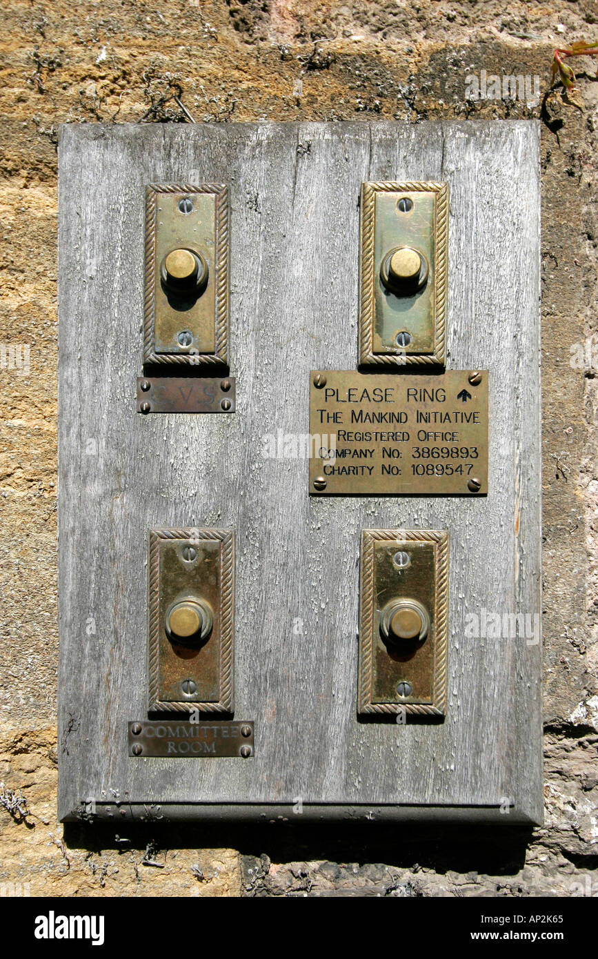 Four brass push button door bells Stock Photo - Alamy