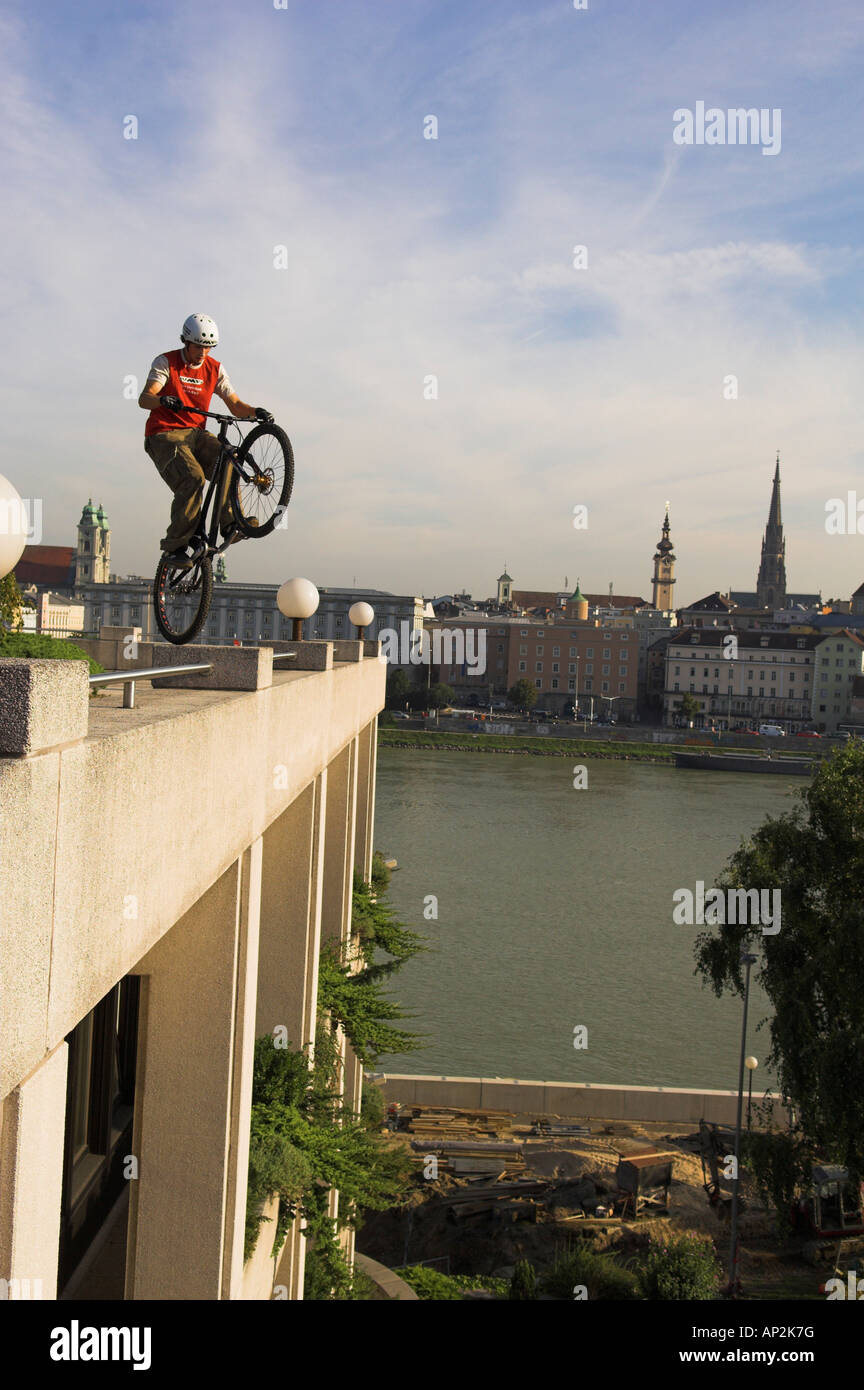 Biker jumping on rear wheel on Town Hall, Linz, Upper Austria Stock ...