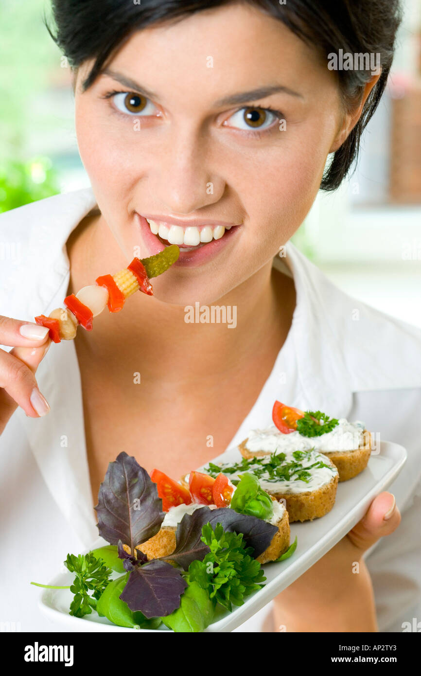 woman eating an appetizer Stock Photo - Alamy