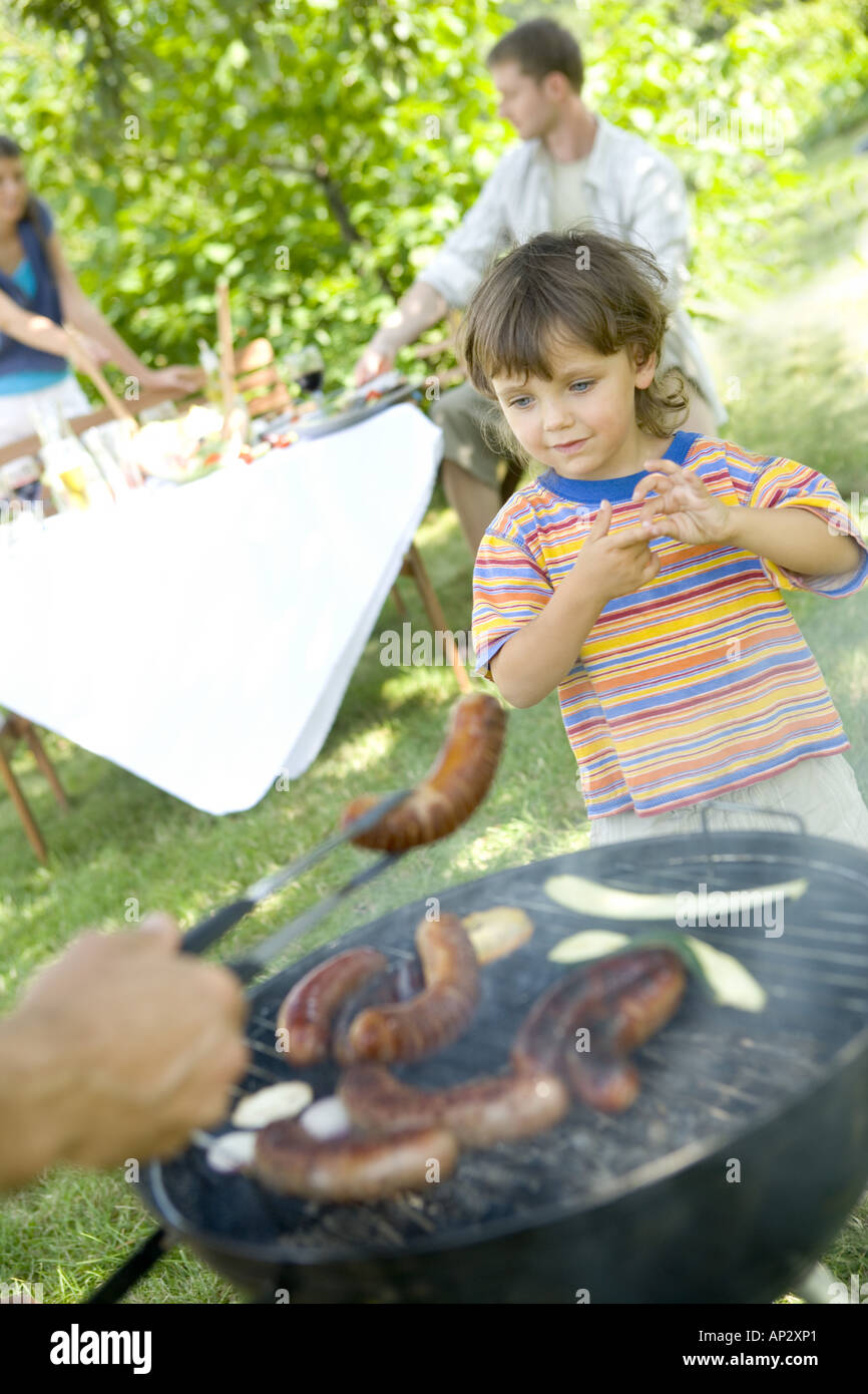 family having barbecue Stock Photo - Alamy