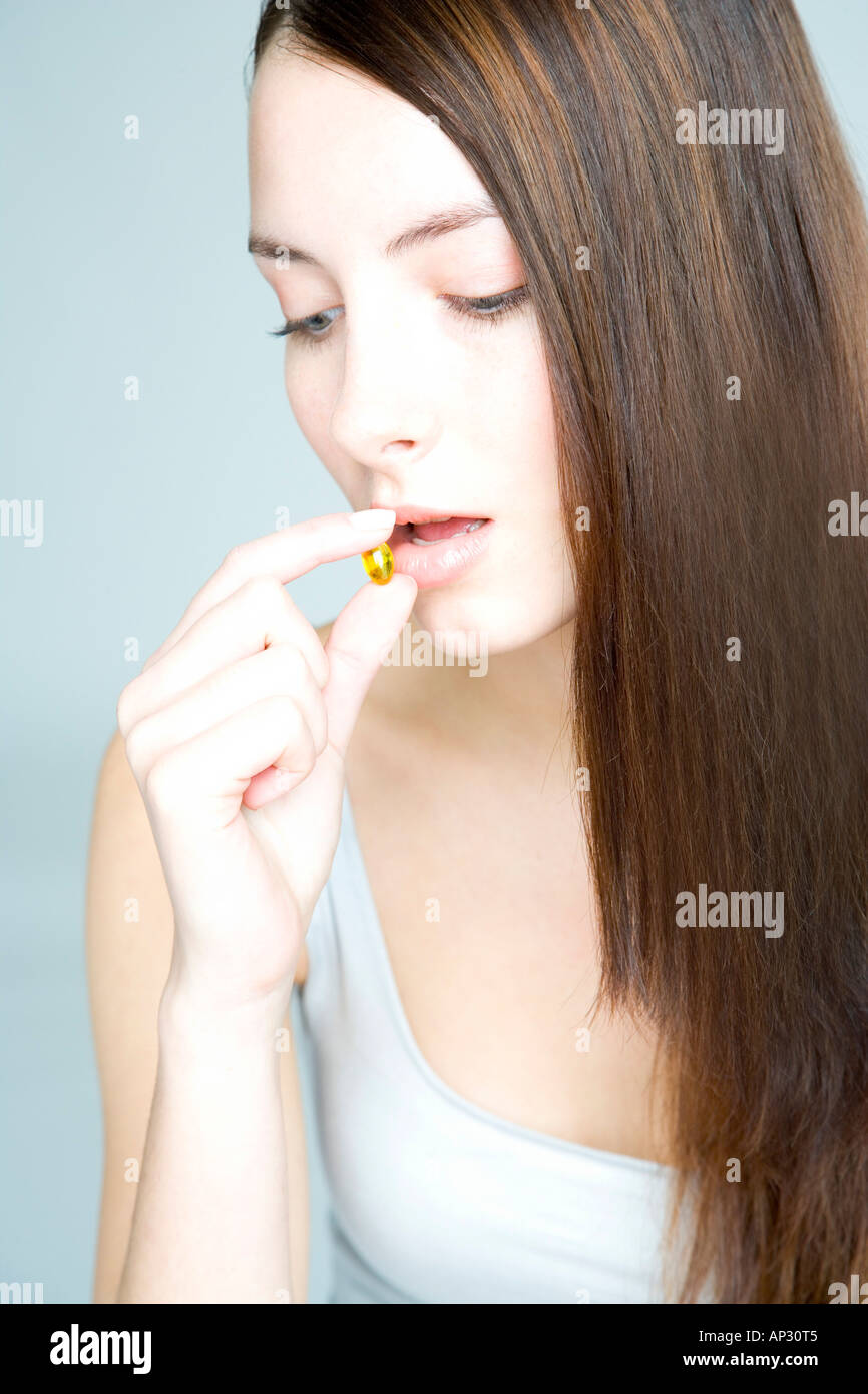 woman taking capsule Stock Photo - Alamy