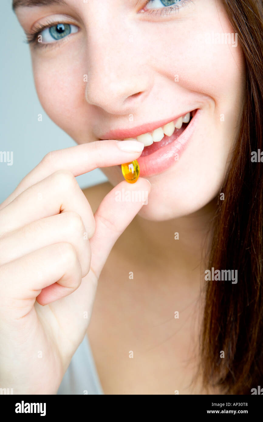 woman taking capsule Stock Photo - Alamy