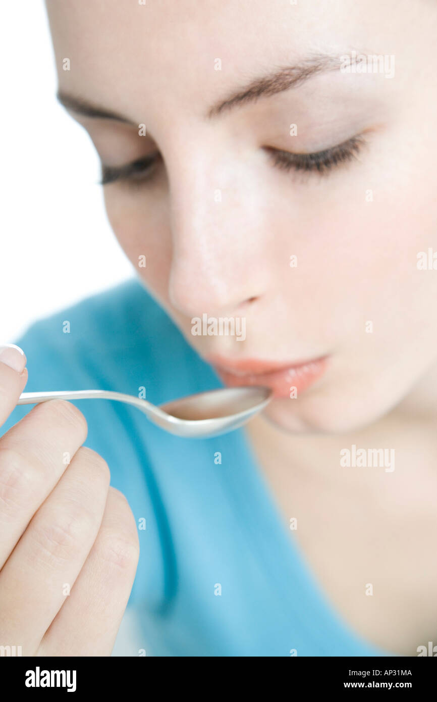 woman taking syrup Stock Photo - Alamy