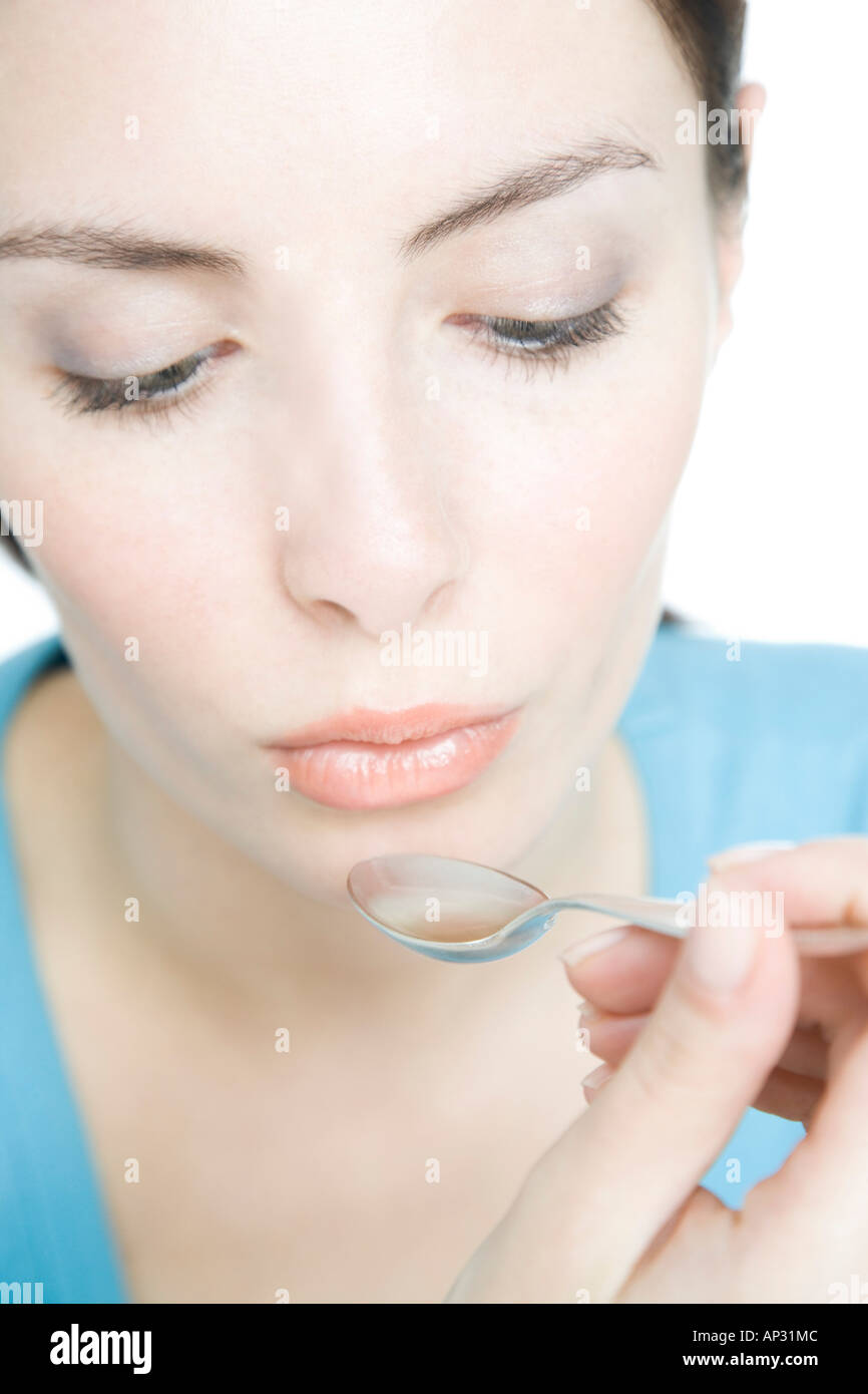 woman taking syrup Stock Photo - Alamy