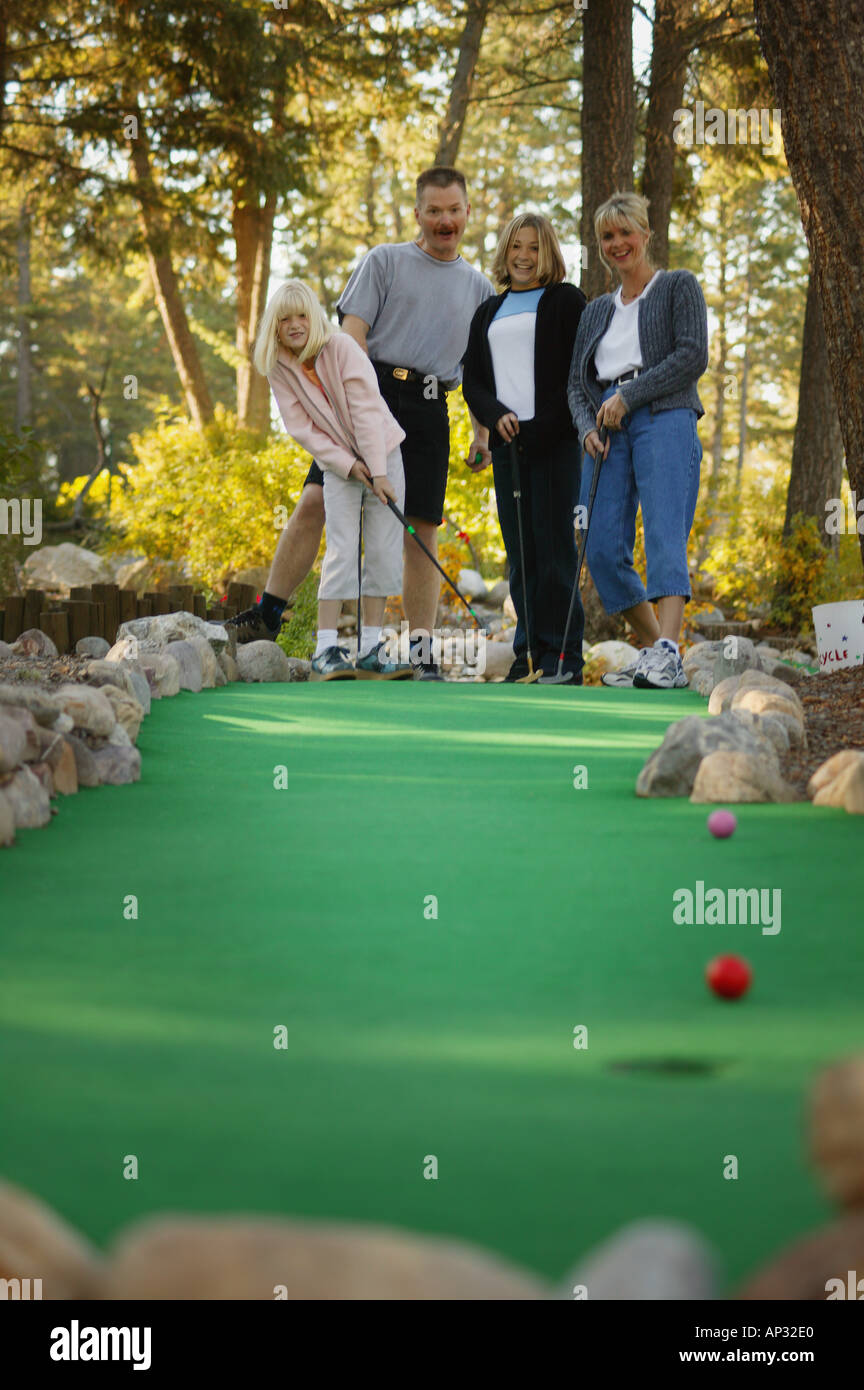Family goes mini golfing Stock Photo - Alamy