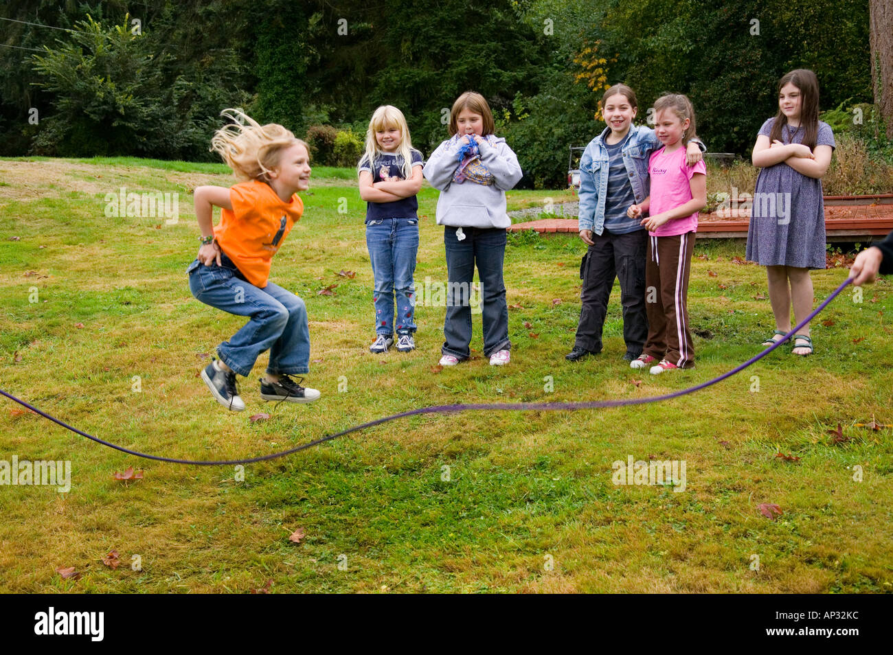 Young girls jumping rope Stock Photo - Alamy