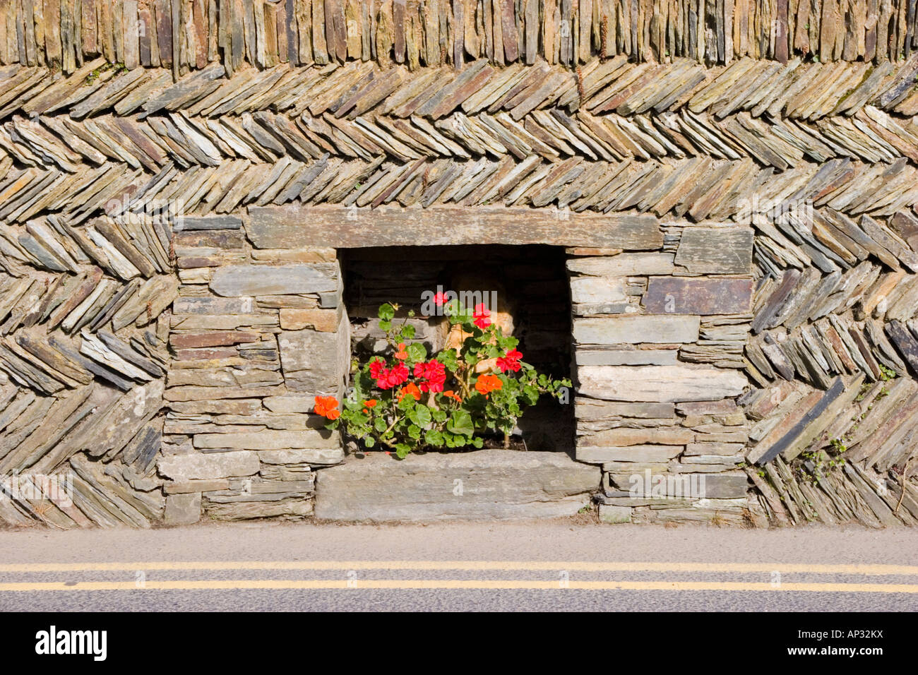 Flowers growing in a niche in a stone wall Stock Photo - Alamy