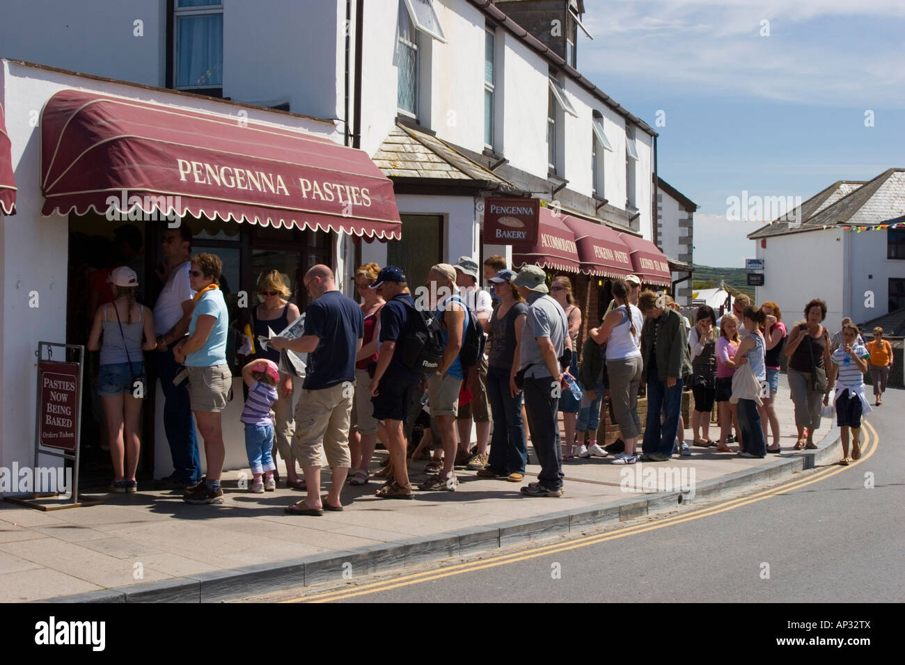 Lunchtime queue to buy Cornish pasties from a bakery in Tintagel ...