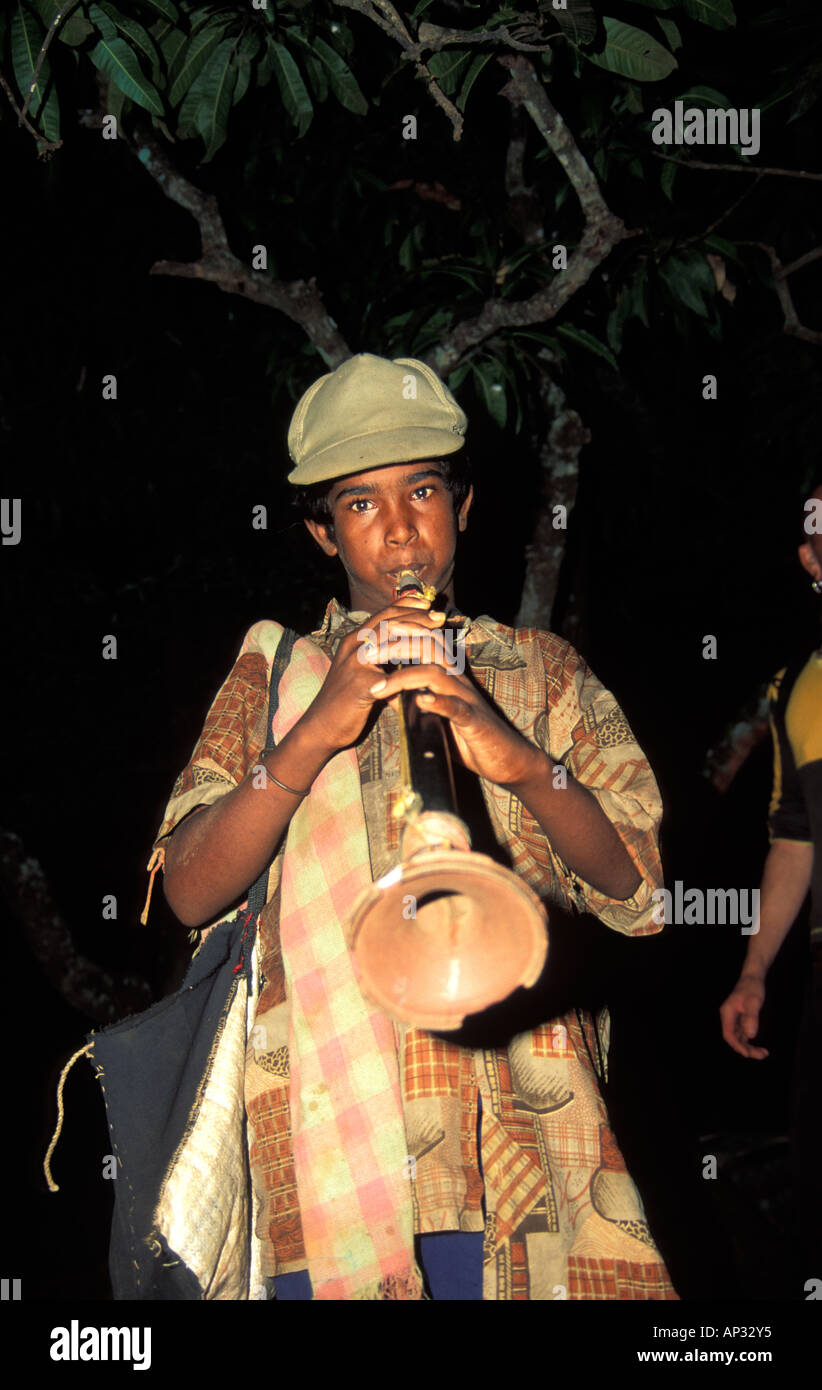 Young Indian lad blowing wind instrument, Hill Tops, Vagator, Goa ...