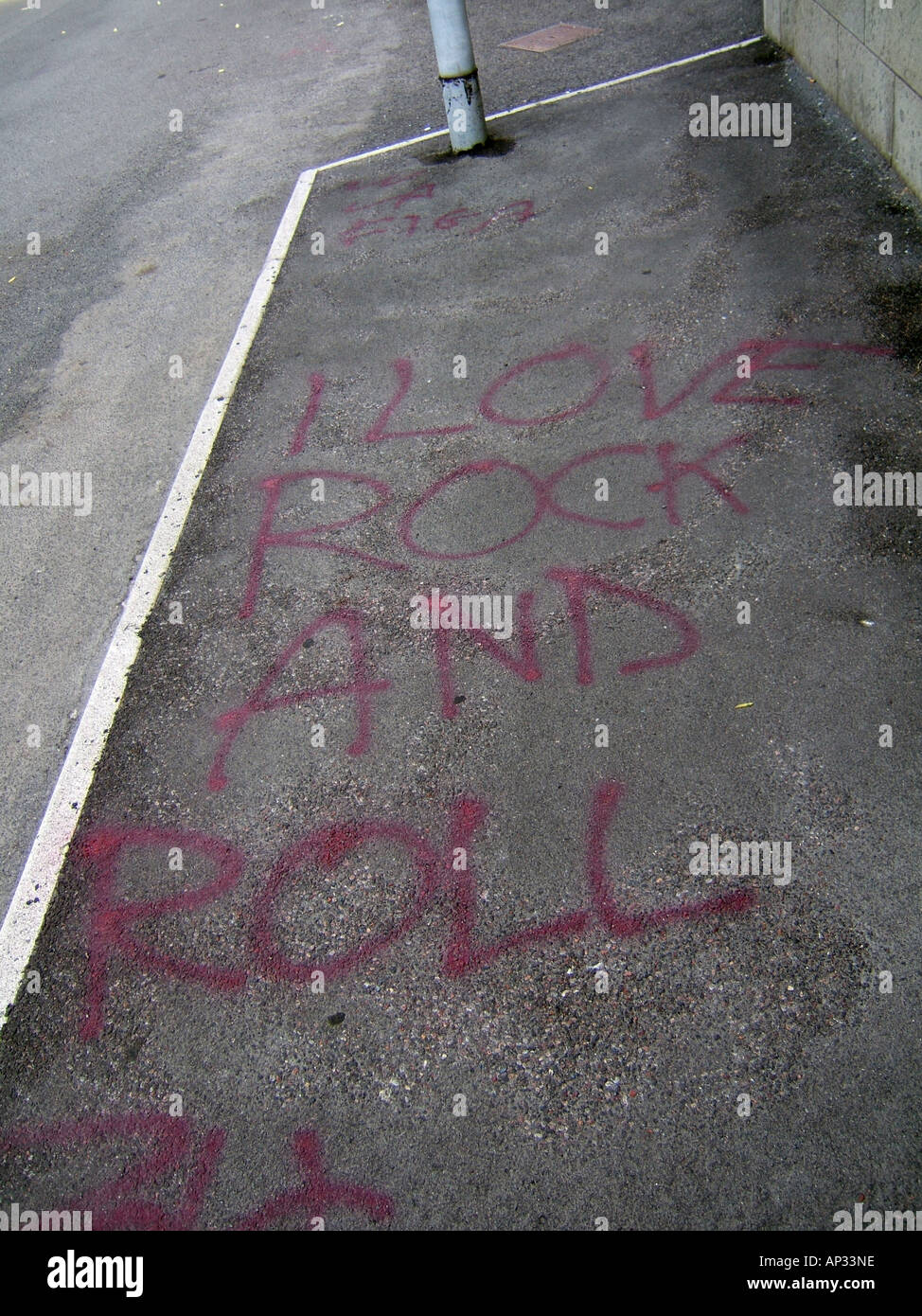 i love rock and roll graffiti on pavement Stock Photo - Alamy