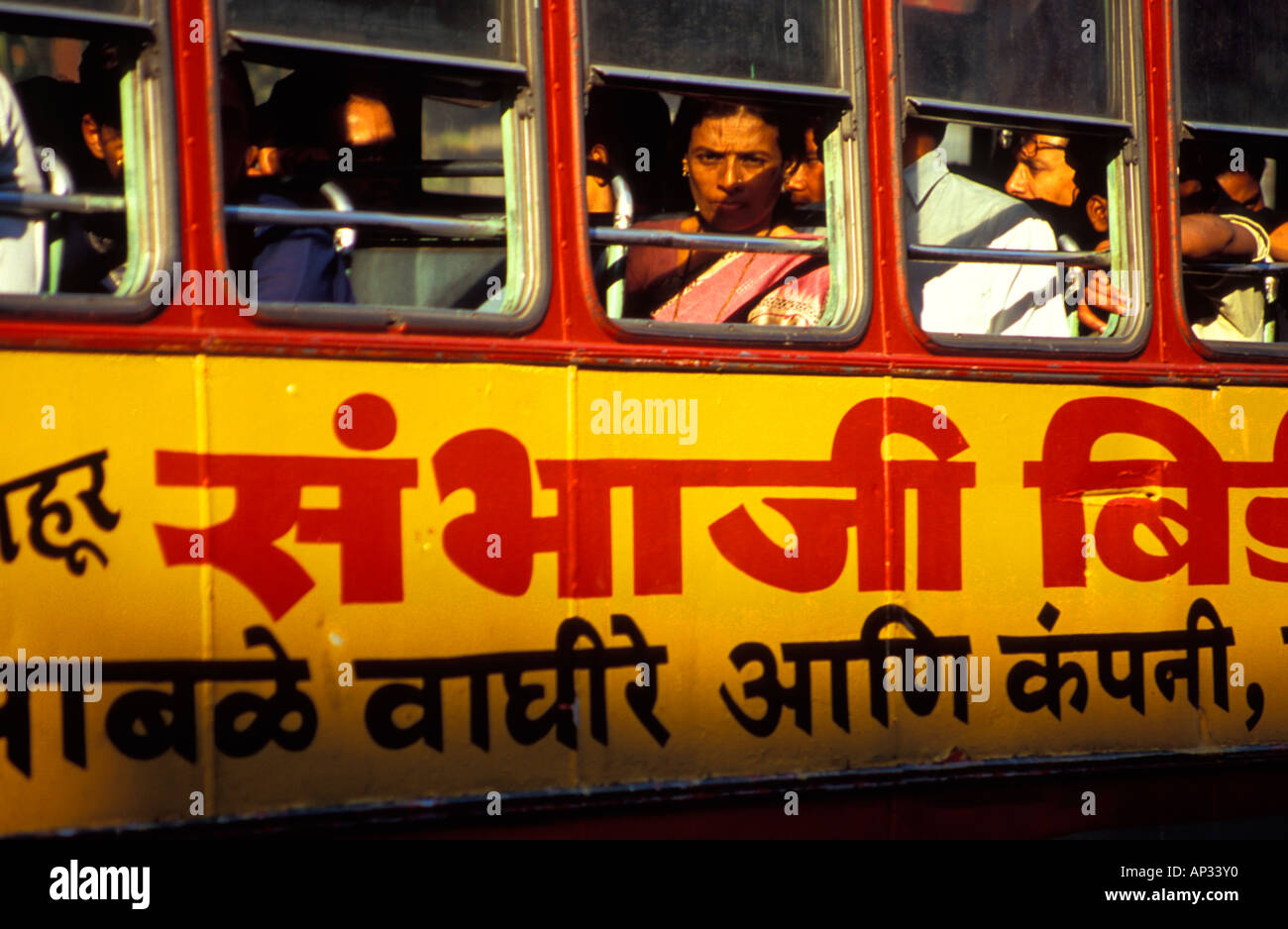 Indian bus passengers seated beside window of bus, Mumbai, South India ...