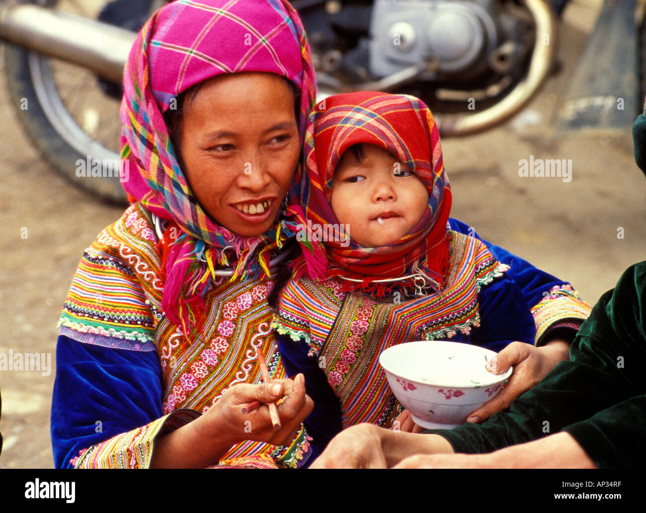 Flower Hmong ethnic minority hill tribe mother feeding rice to child ...