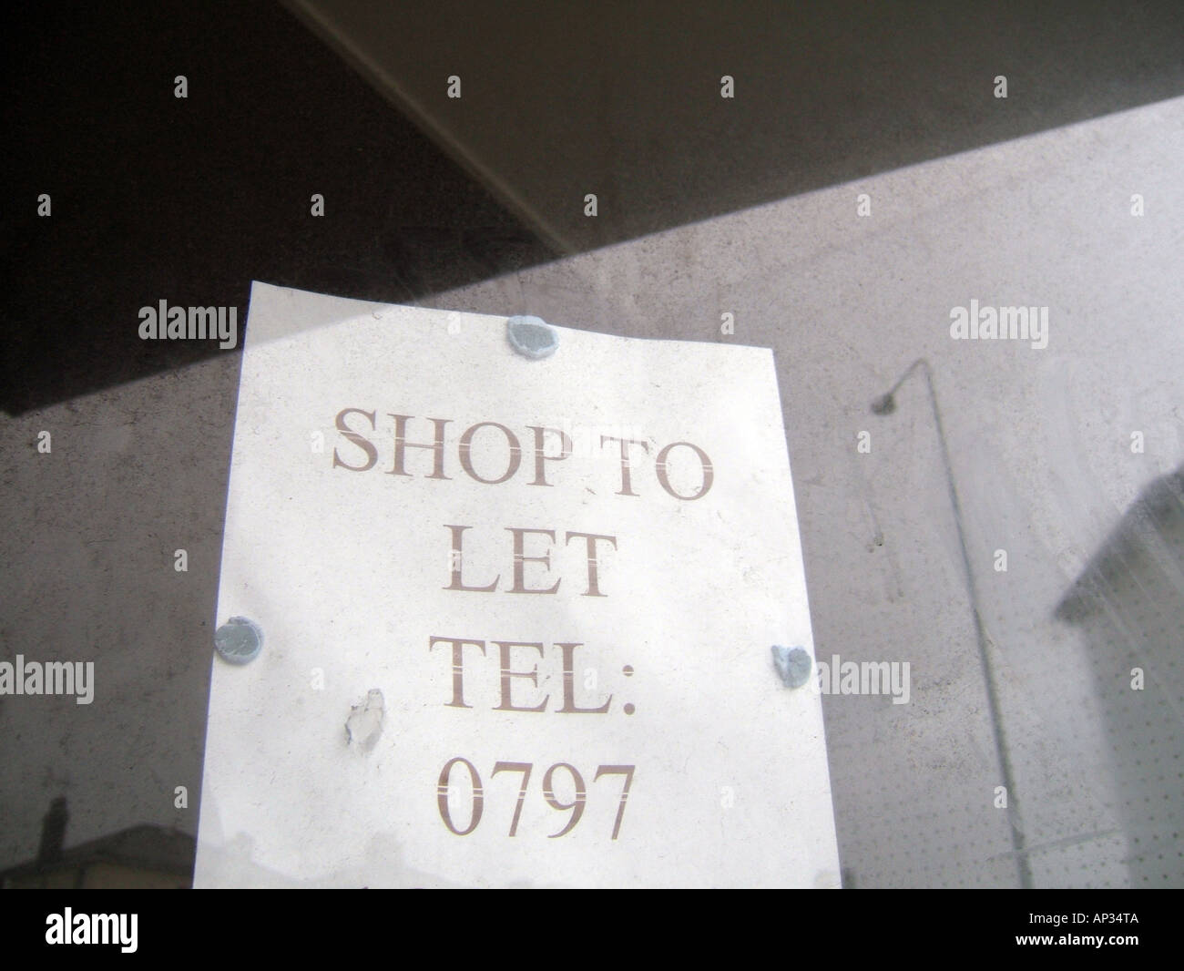 shop to let notice in property window on high street Stock Photo - Alamy