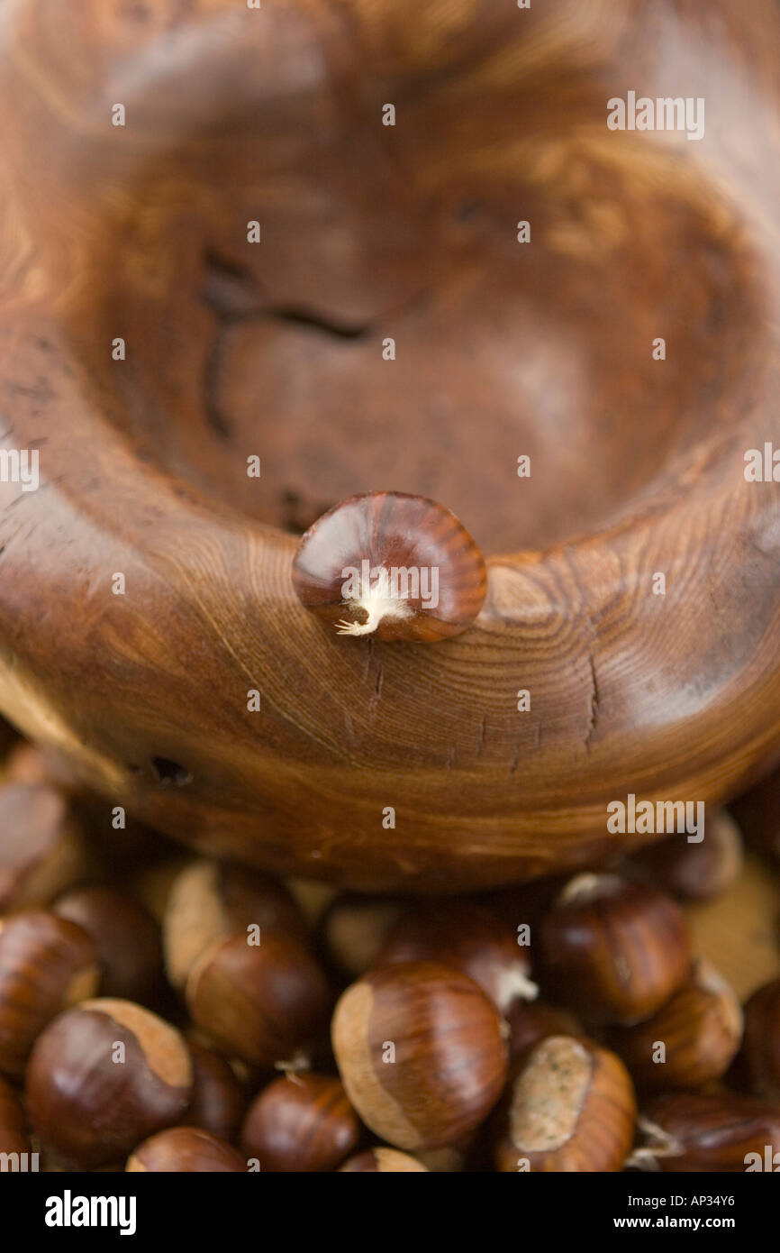 Chestnuts and walnut wood bowl Stock Photo - Alamy