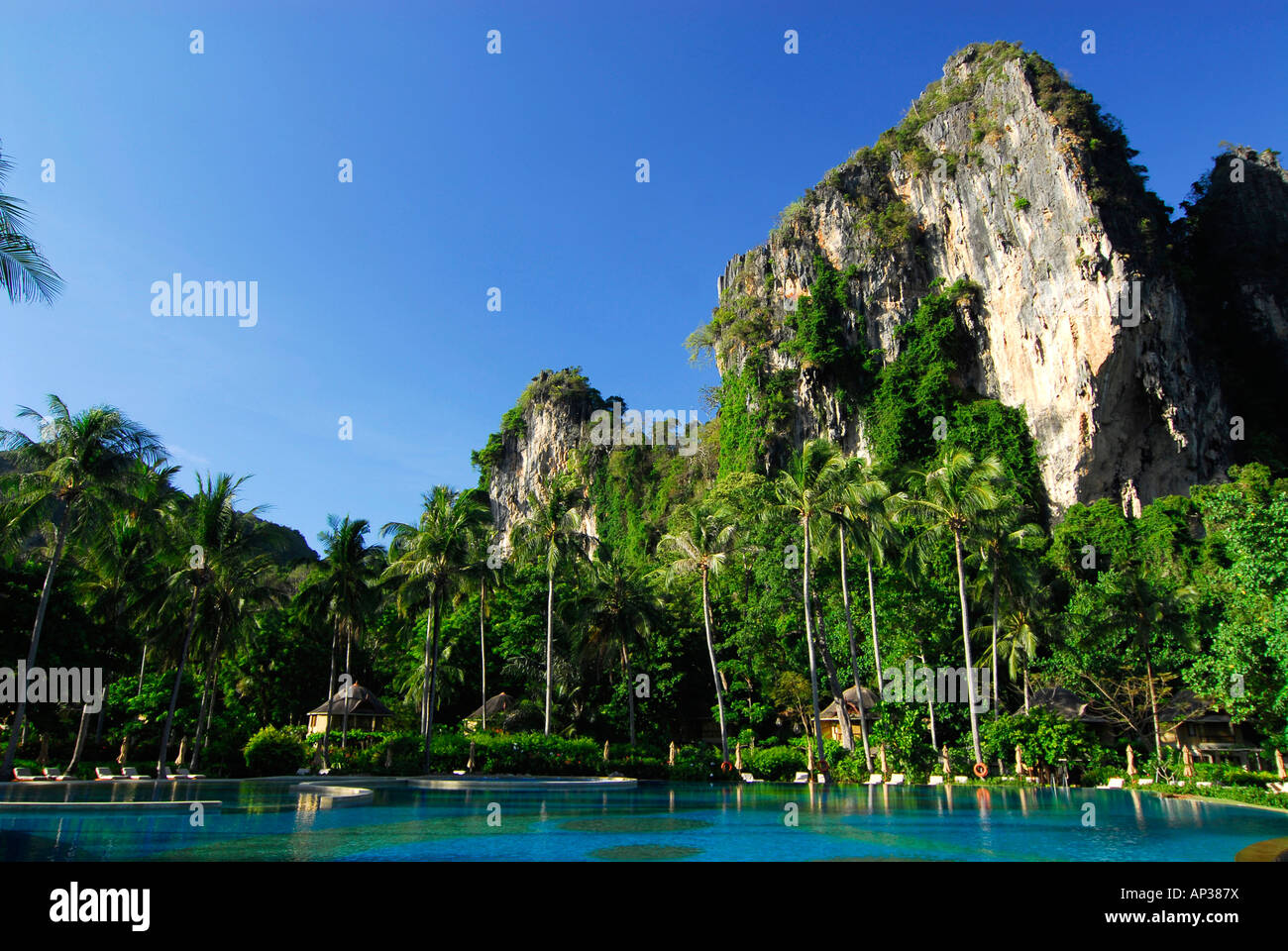 Bungalows in tropical garden of Hotel Rayavadee with limestone cliff ...