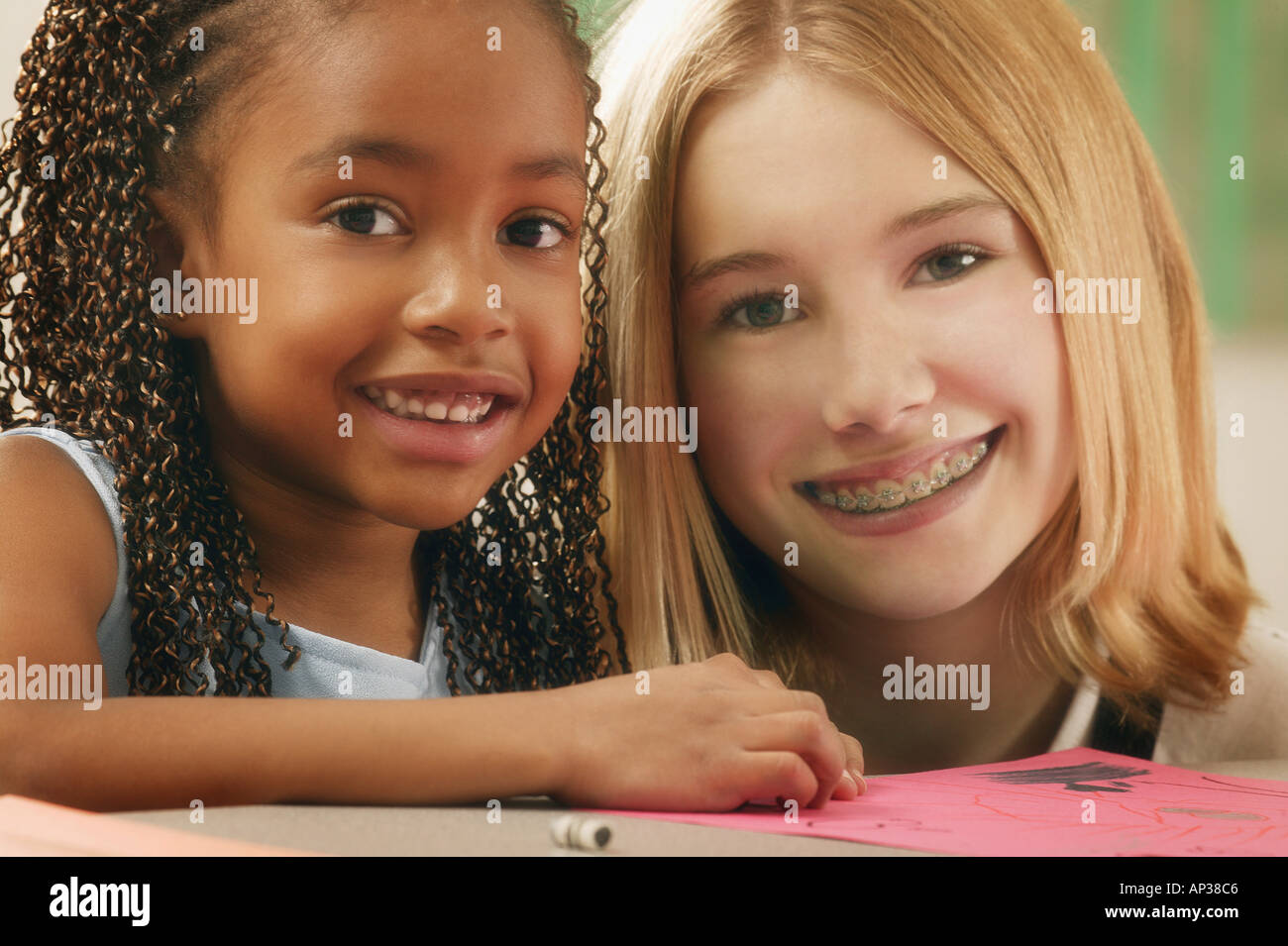 Two girls color together Stock Photo - Alamy
