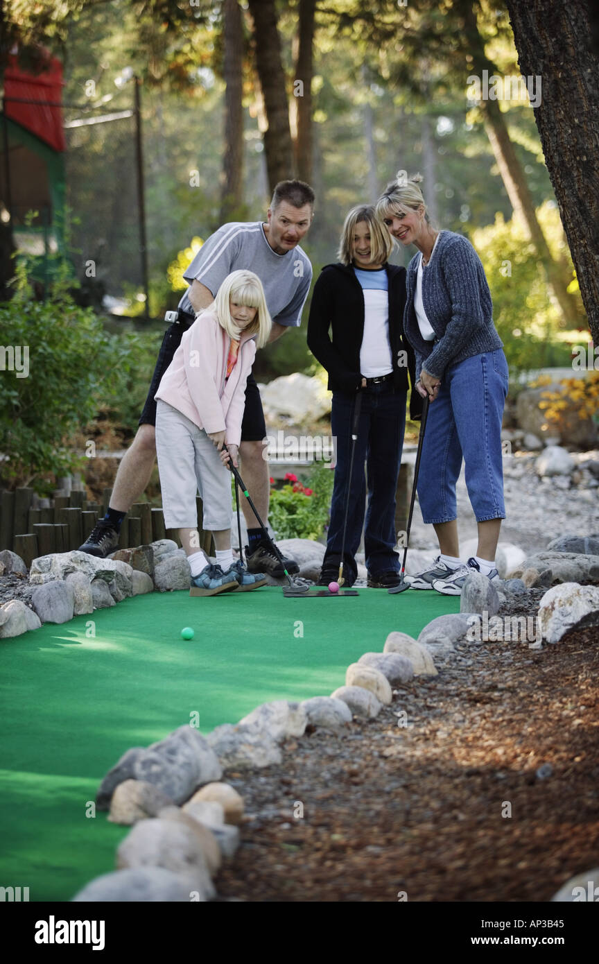 Family plays mini golf Stock Photo - Alamy
