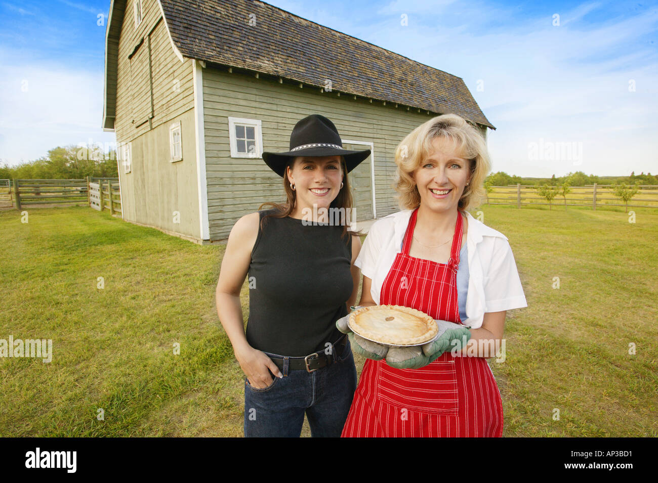 Women in front of a barn Stock Photo - Alamy