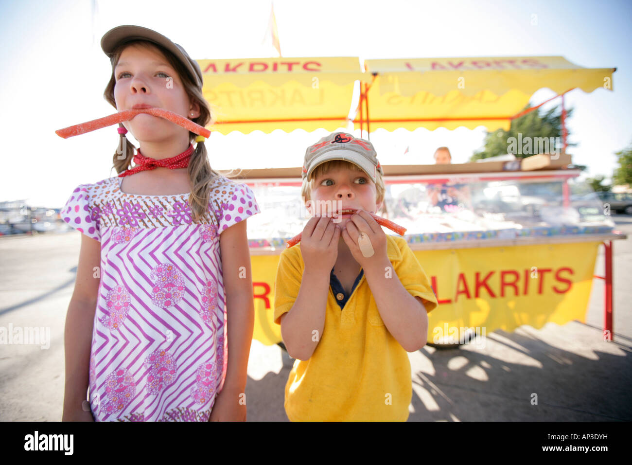 Boy and girl eating candy, typical liquorice, Visby, Gotland, Sweden ...