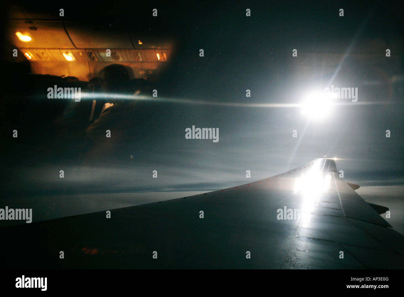 View out of airplane window in the moonlight, reflection of cabin ...