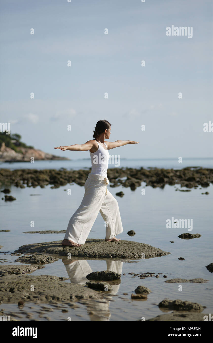 Woman doing Yoga exercises on the beach, Wellness, Relaxation, Health ...