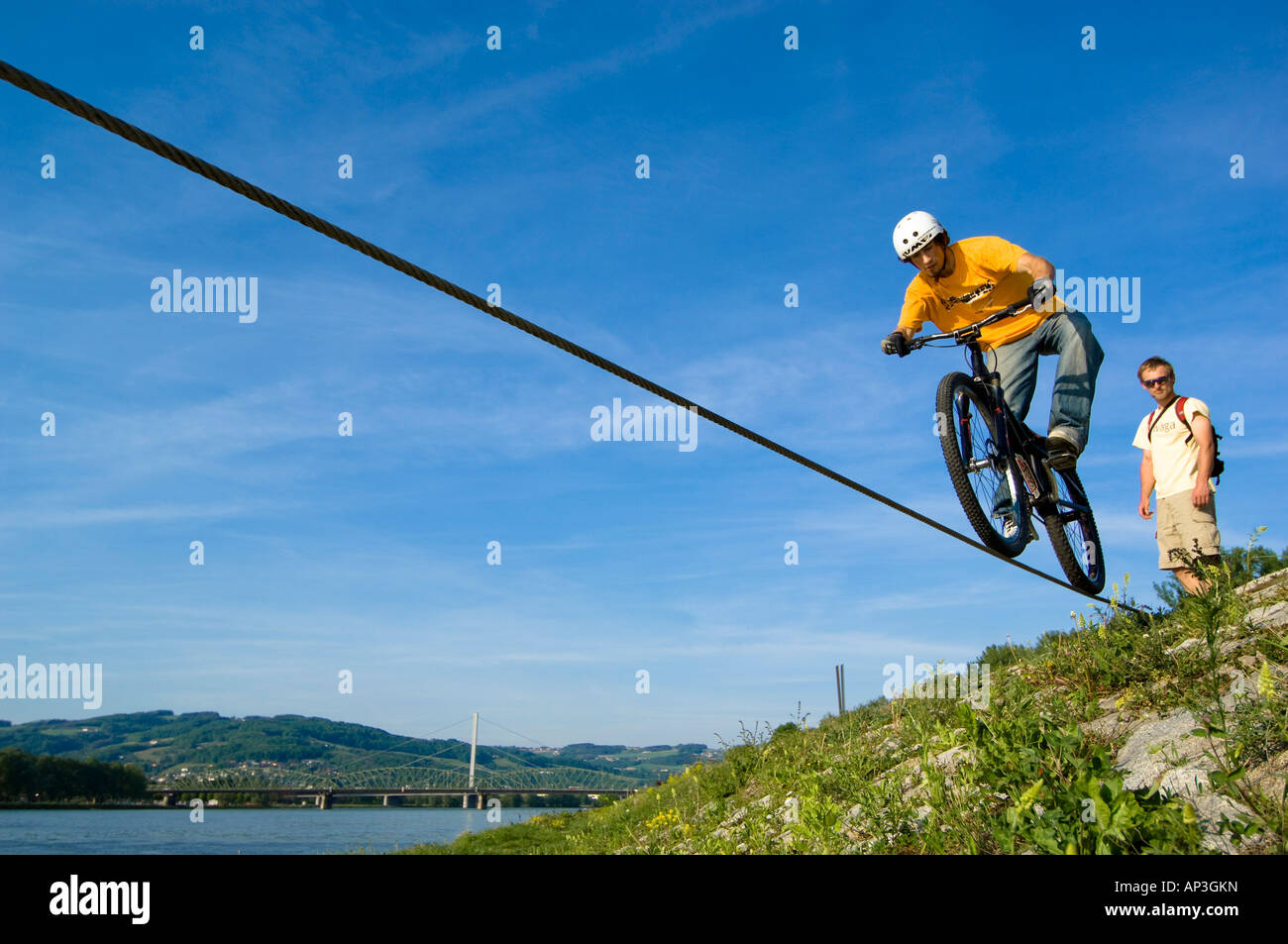 Trial biker on steel rope at Danube River, Linz Stock Photo - Alamy