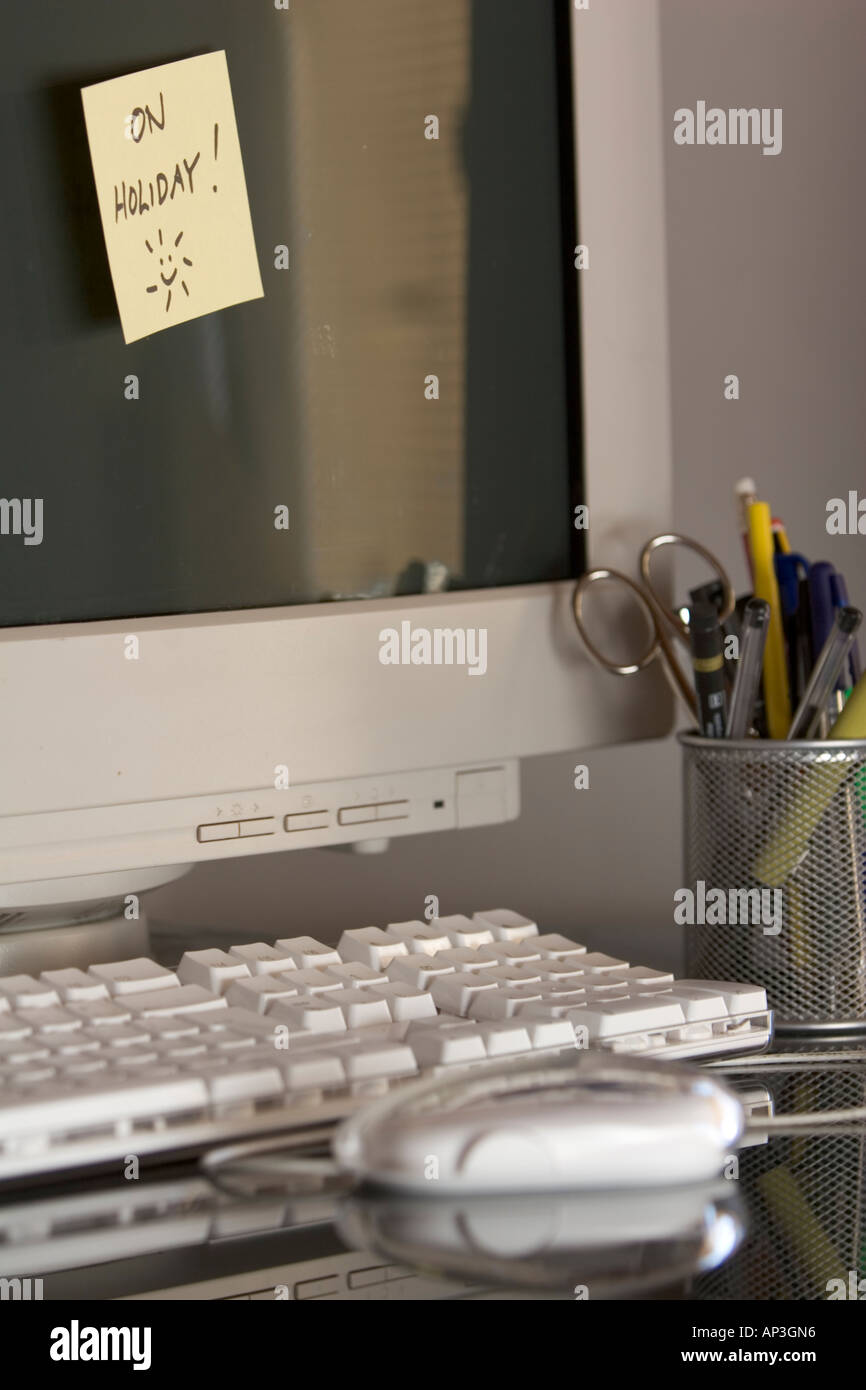 On vacation sticker on computer workstation Stock Photo - Alamy