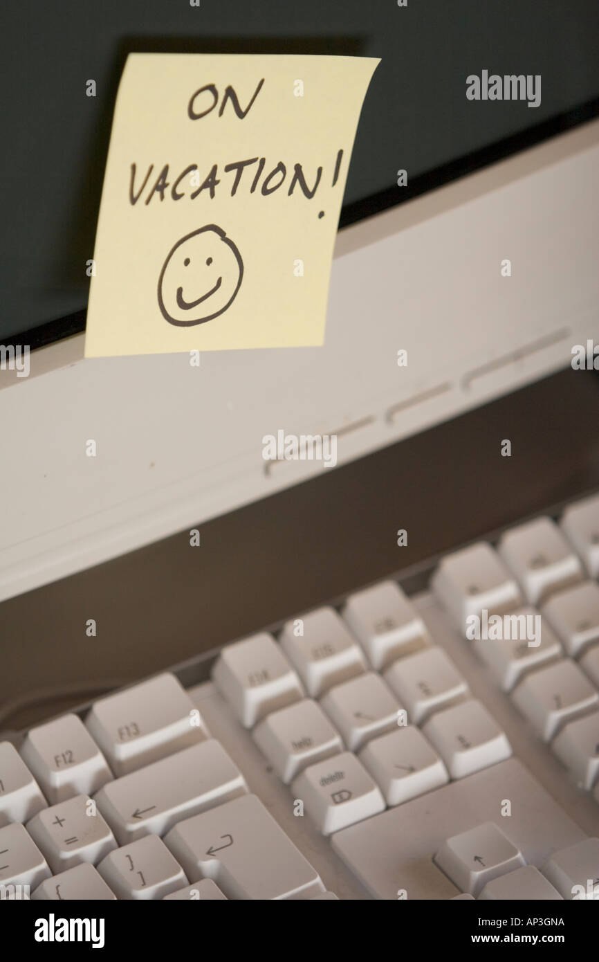 On vacation sticker on computer workstation Stock Photo - Alamy