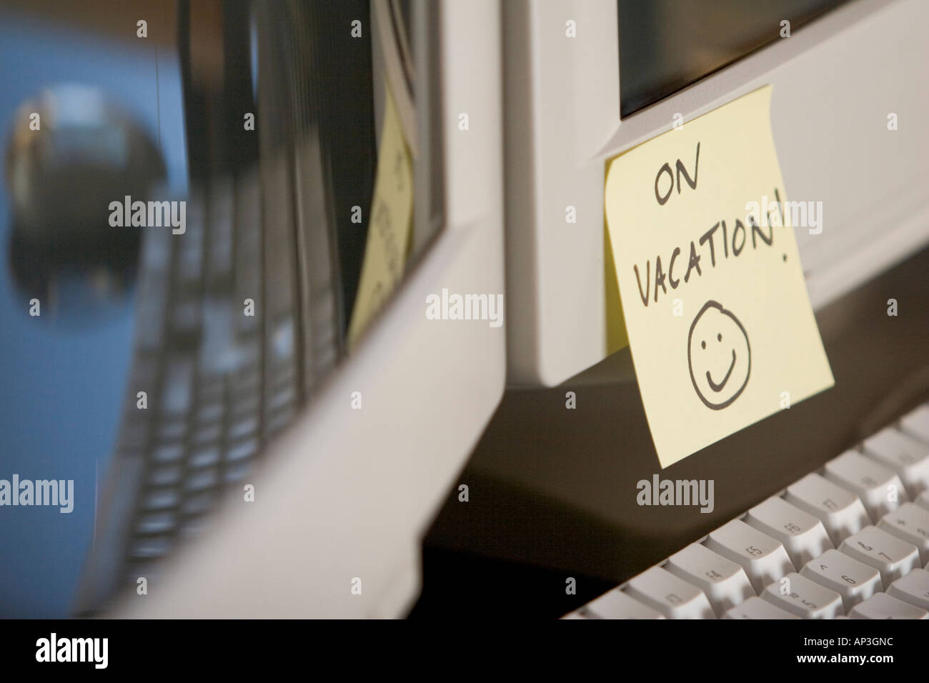 On vacation sticker on computer workstation Stock Photo - Alamy