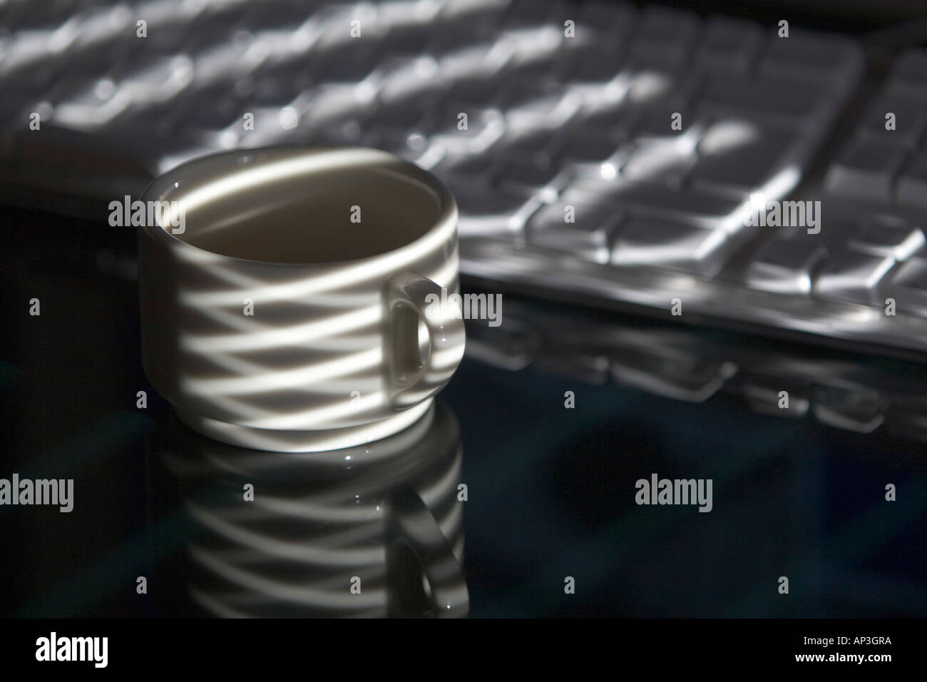Coffee cup and computer workstation keyboard Stock Photo - Alamy