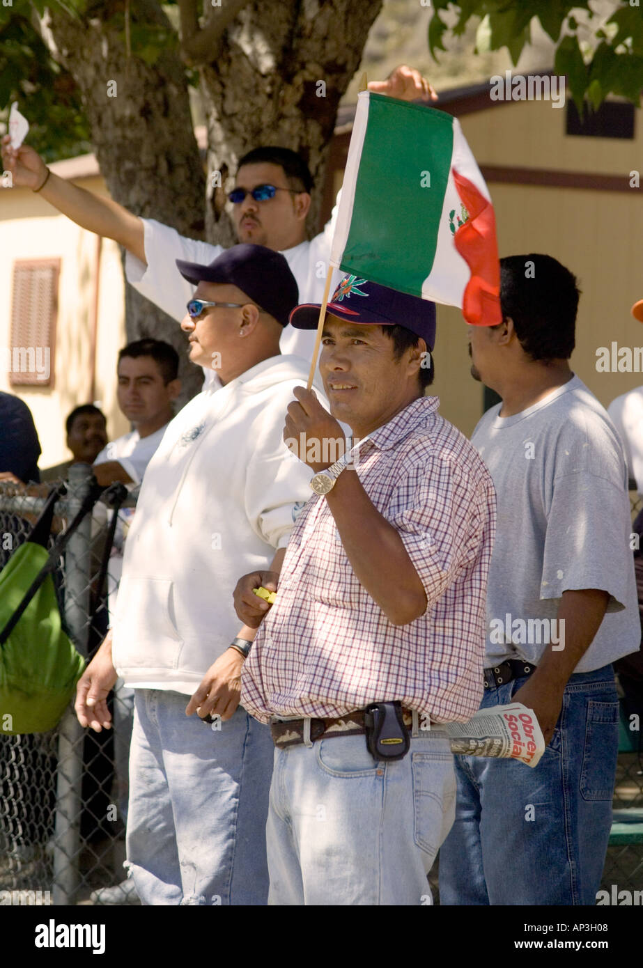 Day laborer waves a small Mexican flag at pro-laborer demonstration in ...