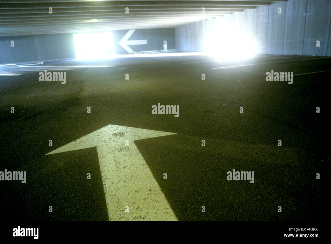 Directional arrow in parking garage on pavement Stock Photo - Alamy