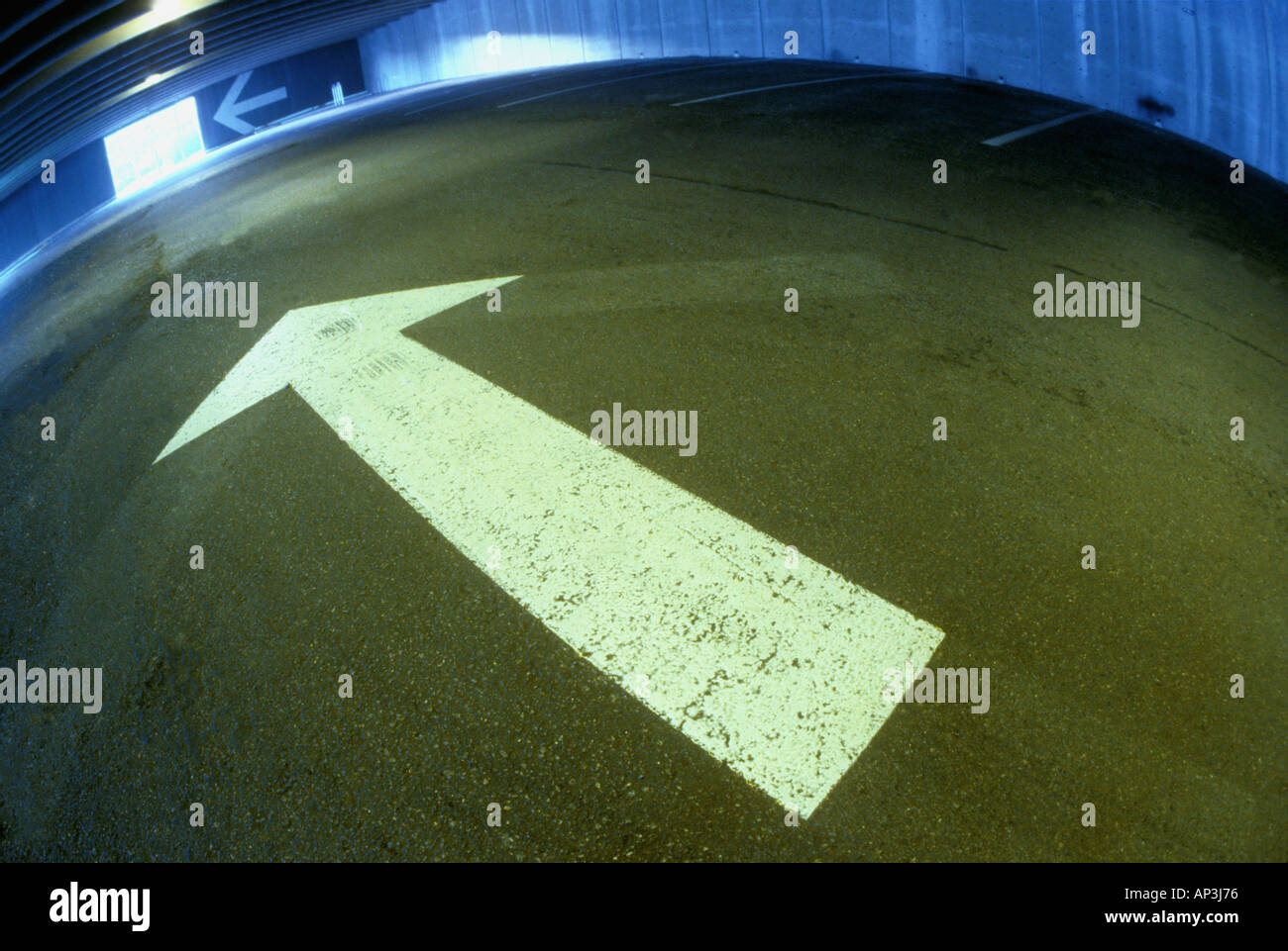 Directional arrow in parking garage on pavement Stock Photo - Alamy