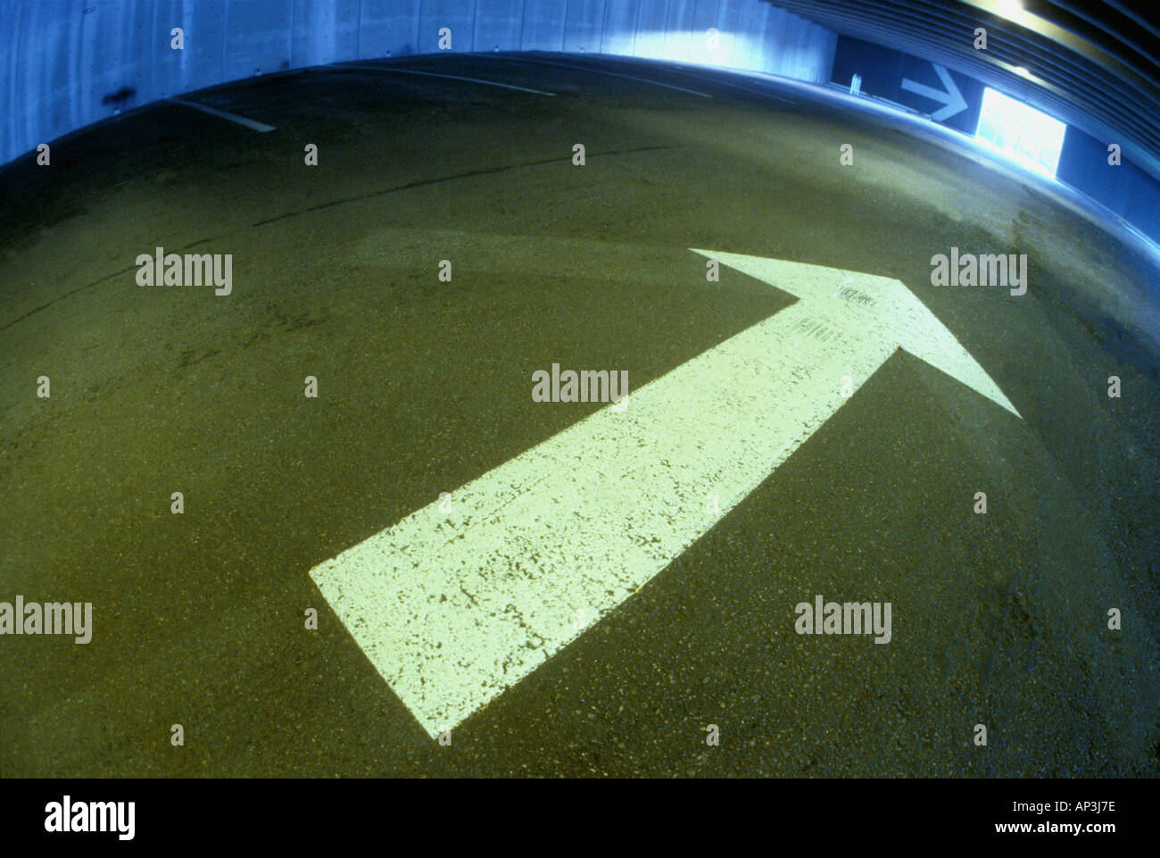 Directional arrow in parking garage on pavement Stock Photo - Alamy