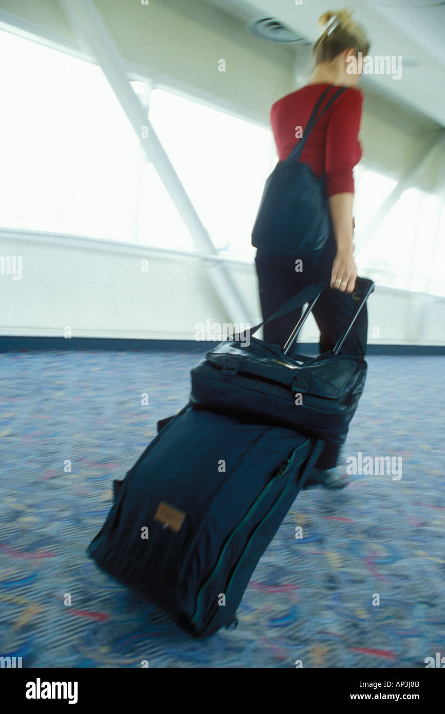 Pulling rolling suitcases hi-res stock photography and images - Alamy