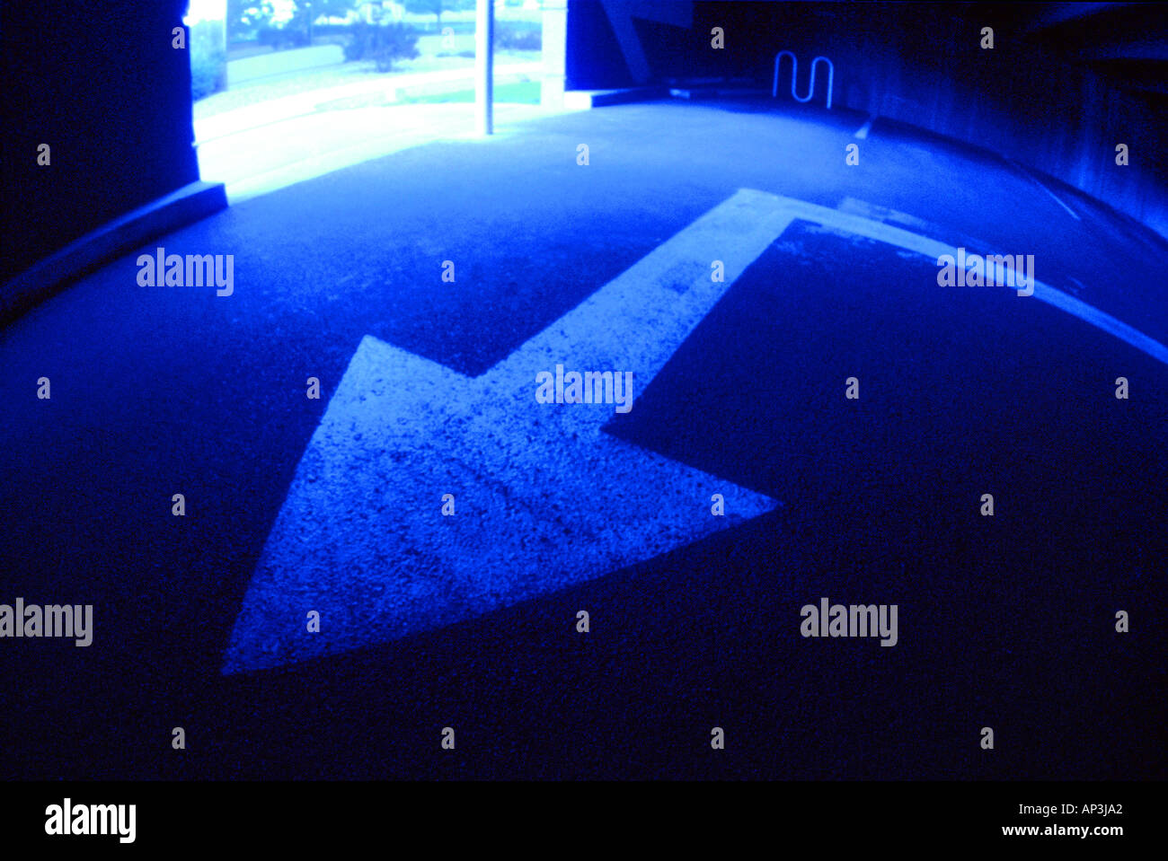 Directional arrow in parking garage on pavement Stock Photo - Alamy