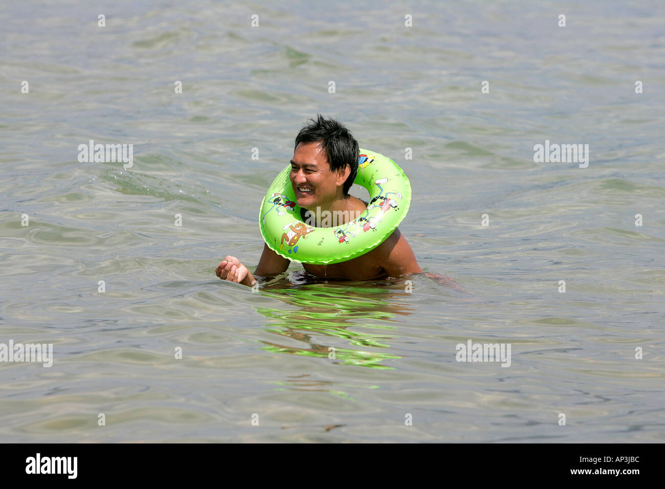 Japanese man father swimming inflatable lift belt float toy bay pier ...